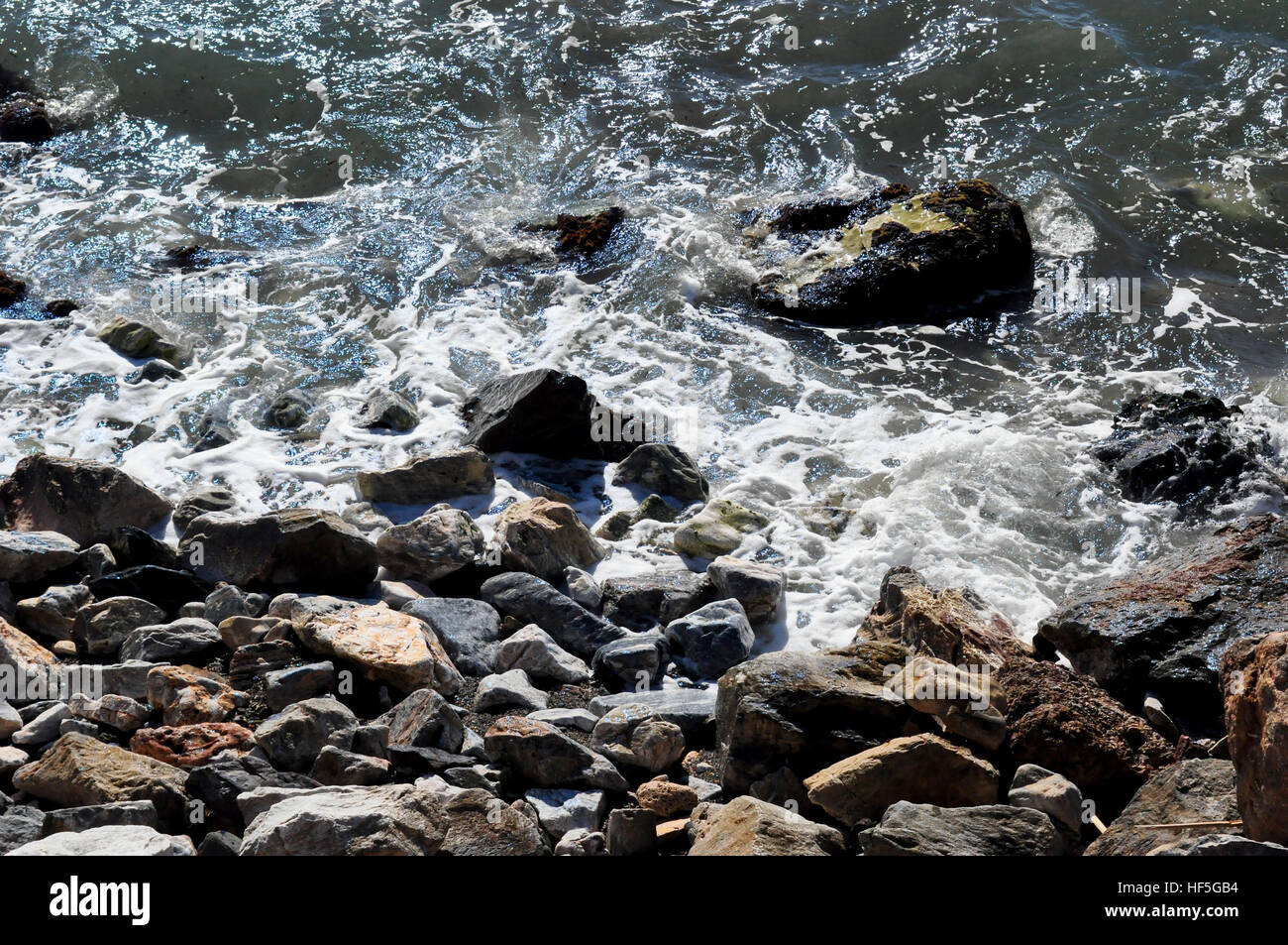 sea, rocks and iridescent reflections Stock Photo - Alamy