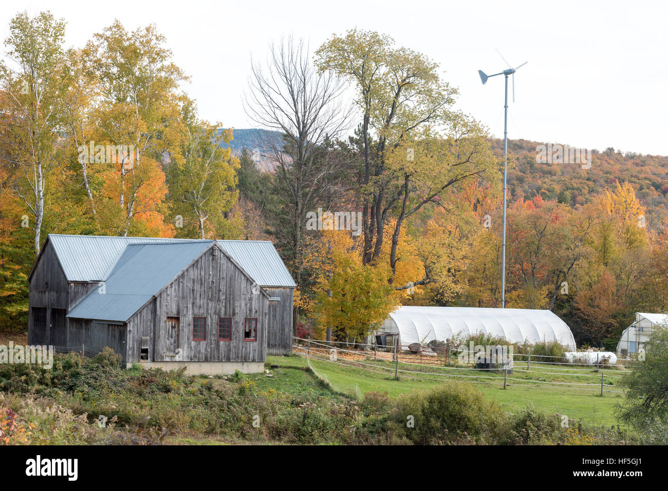 Wind turbine and greenhouses outside a home in Vermont's Green ...