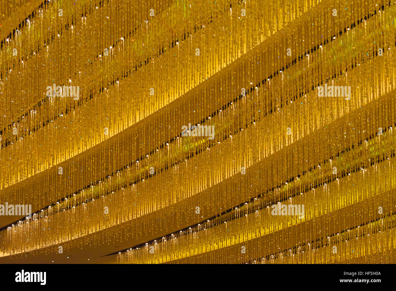 Crystal lamps creating a wave-like formation in the lobby of Sheraton ...