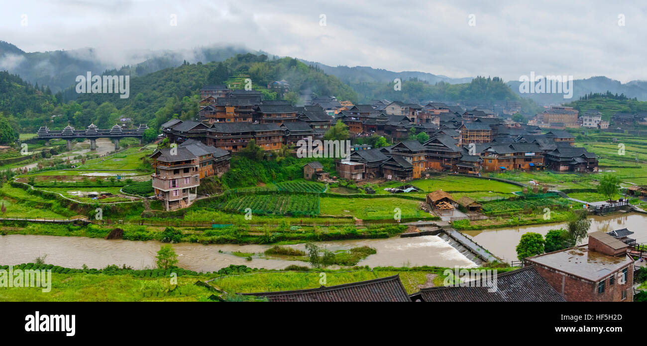 Village with farmland in morning mist, Chengyang, Sanjiang, Guangxi ...