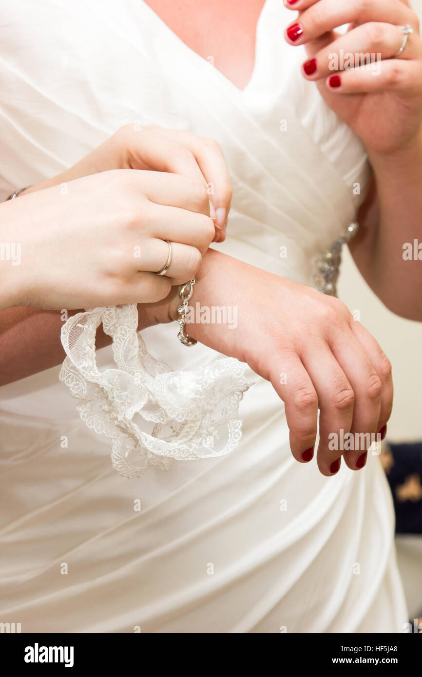 closeup of hands dressing a bride Stock Photo - Alamy