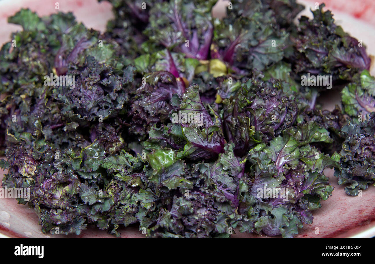 Kalettes being prepared, cooked and served in a scallop dish Stock ...