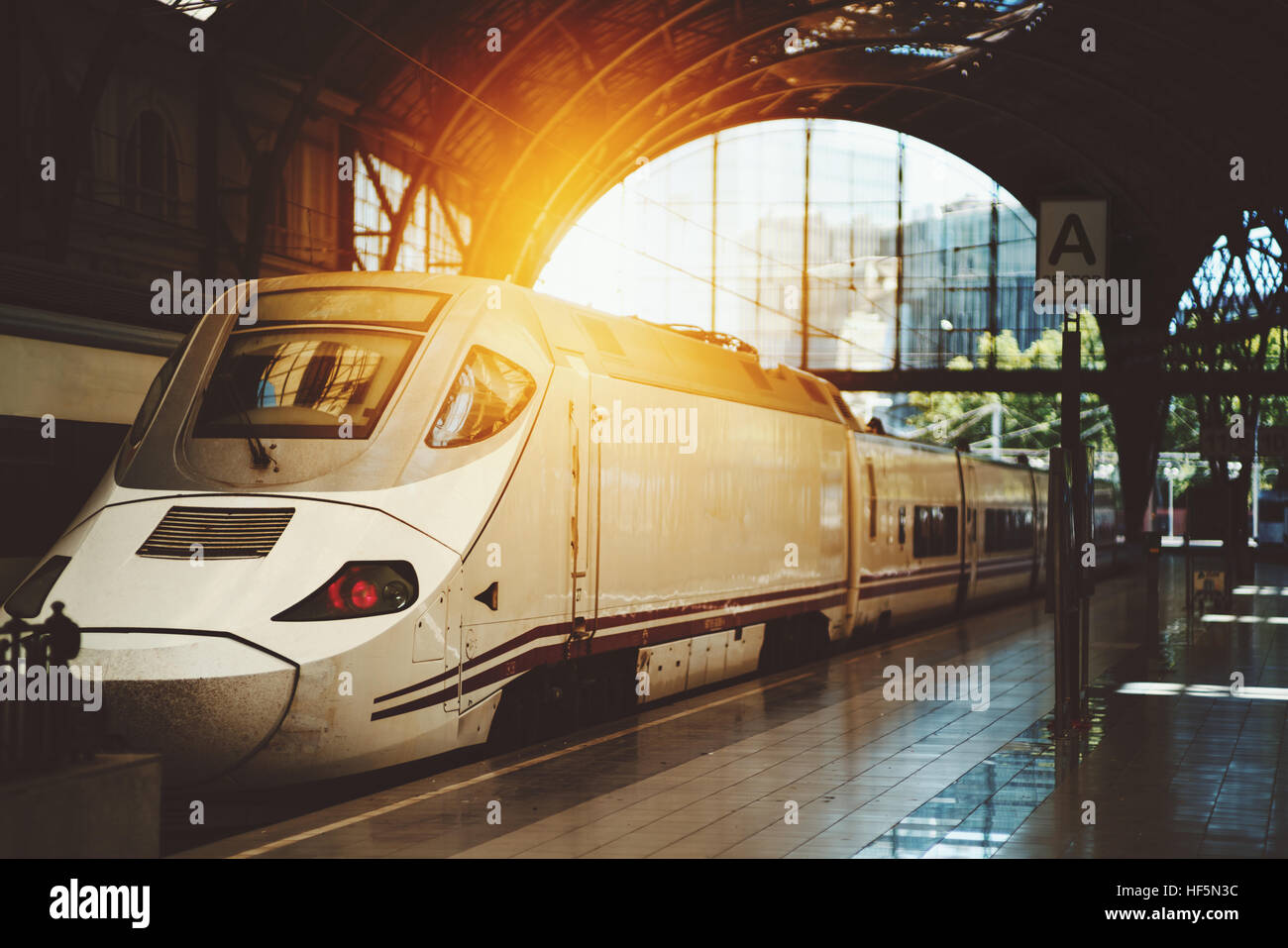 Modern contemporary white train with acuminate face at the station of ...