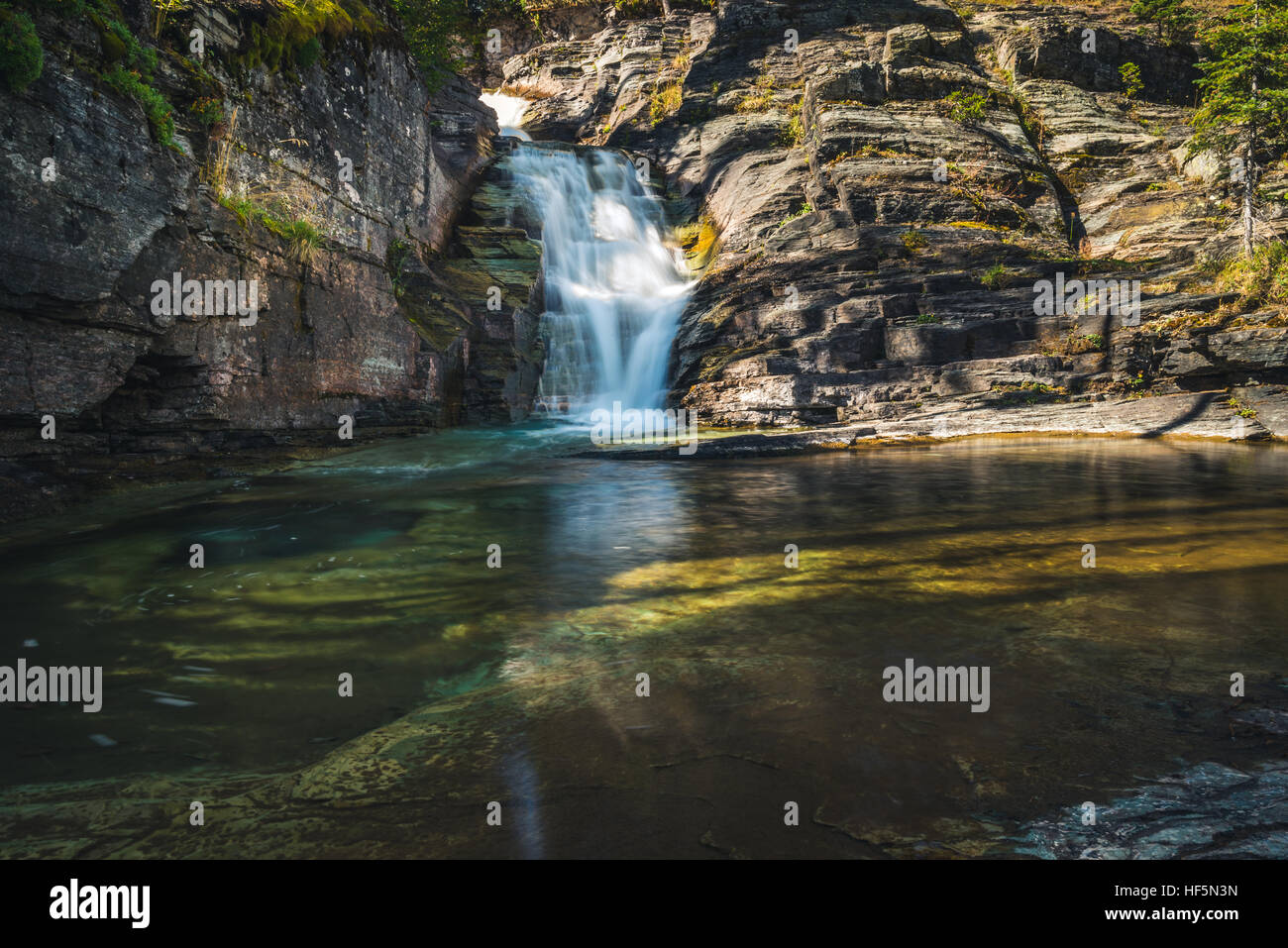 Waterfall flowing into a pond Stock Photo - Alamy