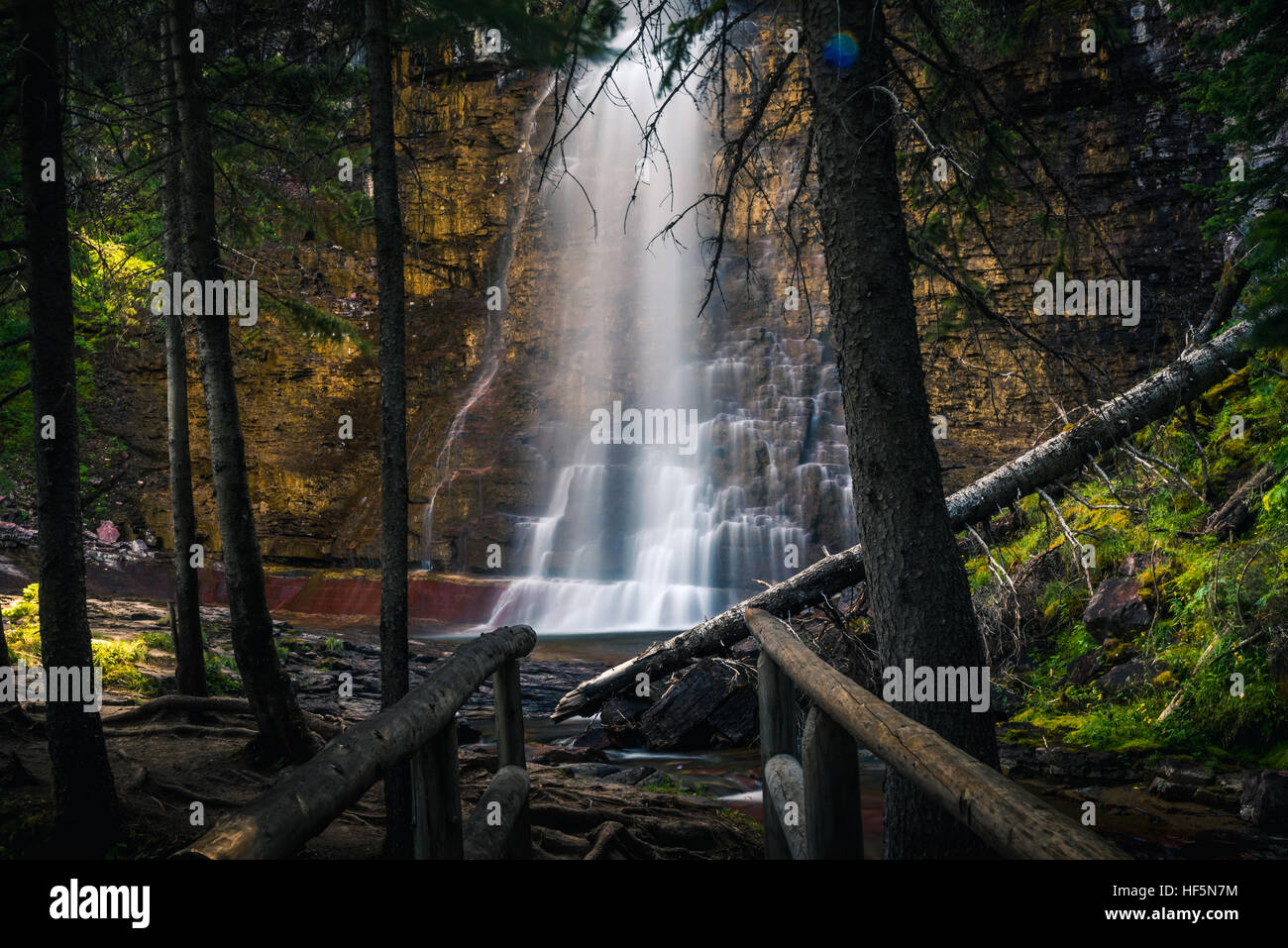 Bridge leading to a waterfall Stock Photo - Alamy