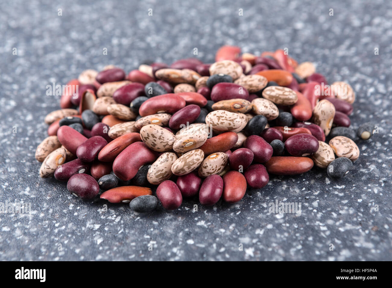 Chili bean mix on a mottled grey blue background Stock Photo - Alamy