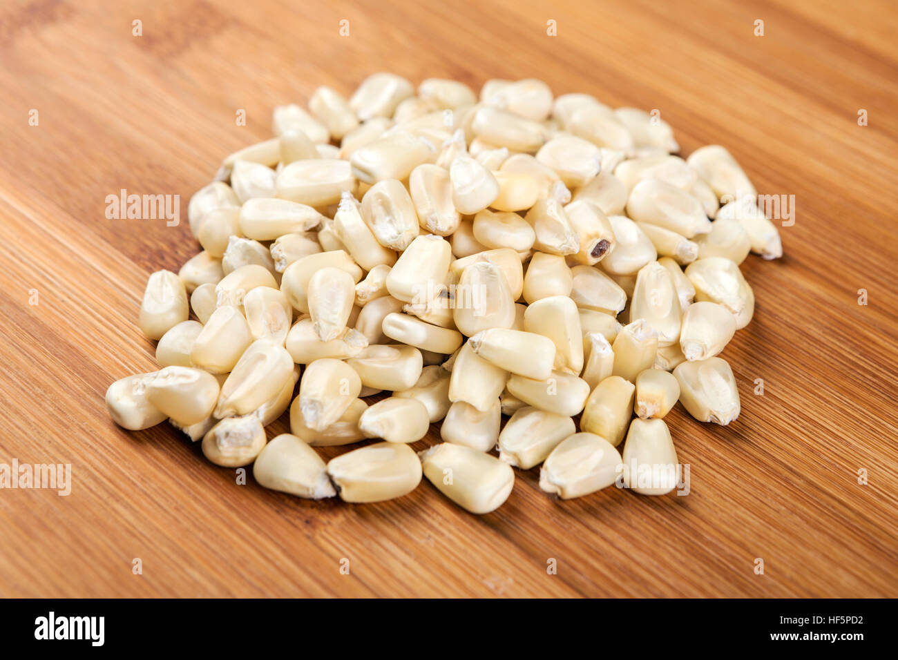 White hominy posole isolated on a wood background Stock Photo - Alamy