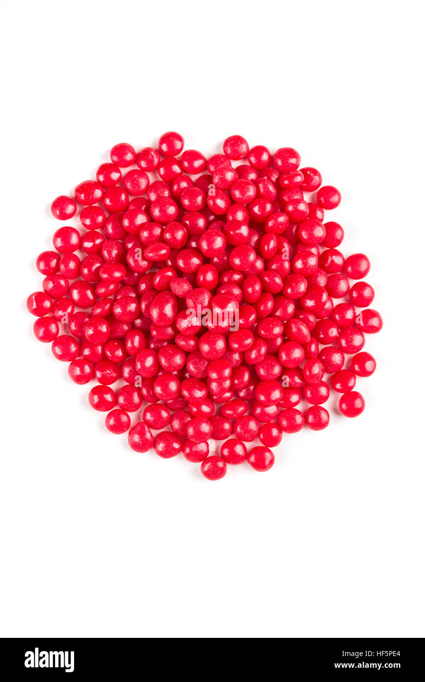 Red cinnamon candies isolated on a white background Stock Photo - Alamy
