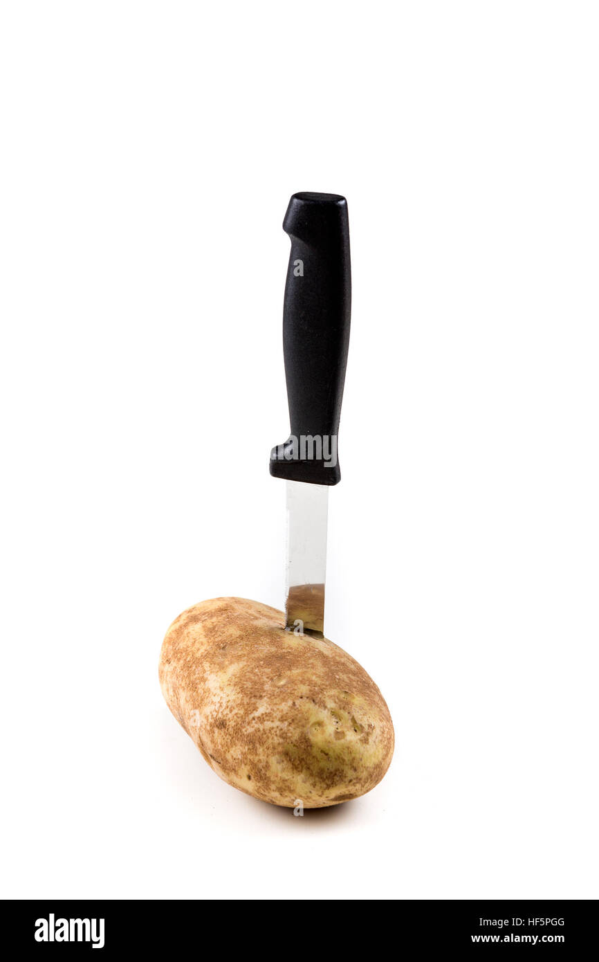 One potato stabbed with a knife isolated on a white background Stock ...