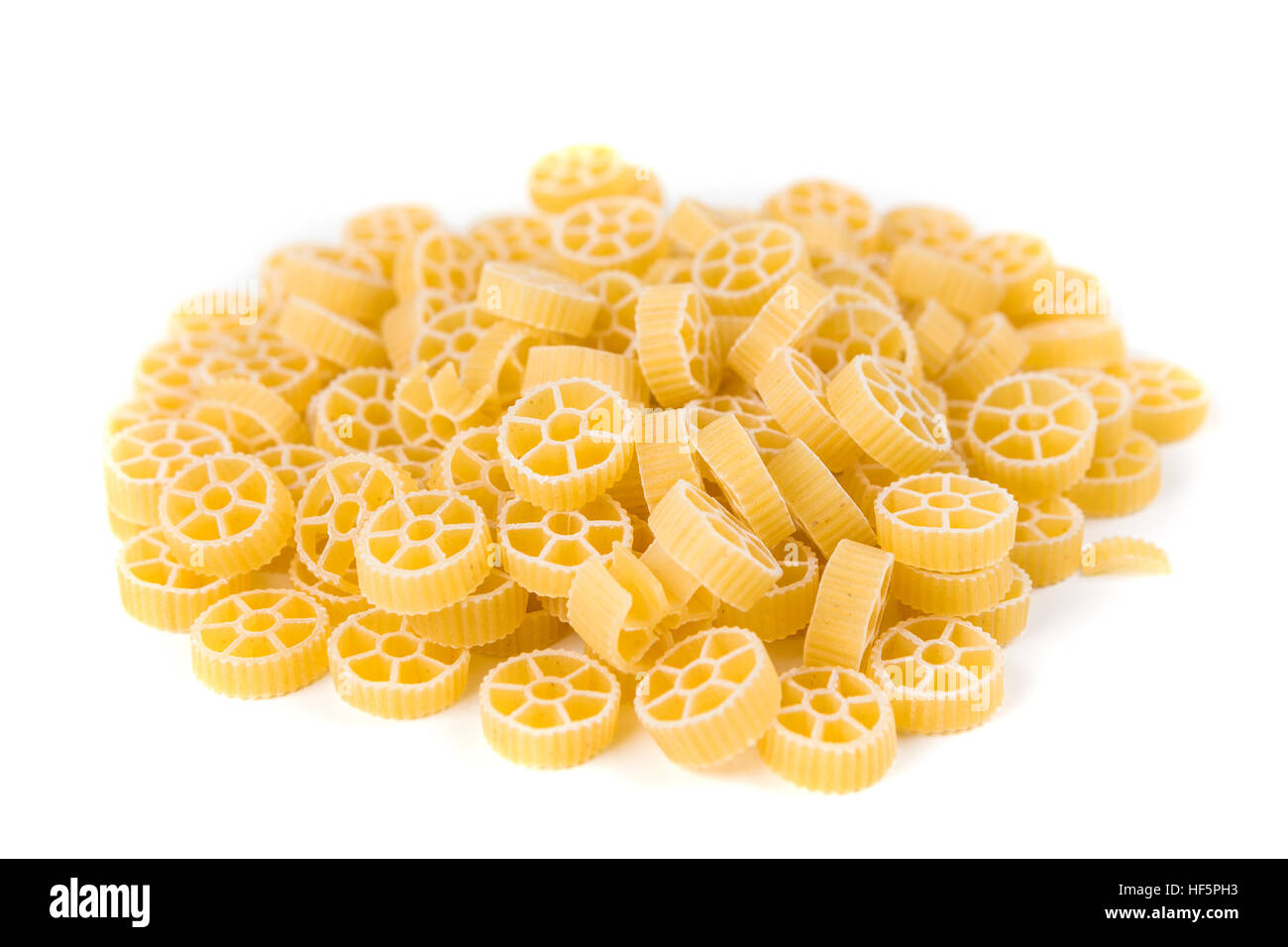 Wheat wagon wheel pasta isolated on a white background Stock Photo - Alamy
