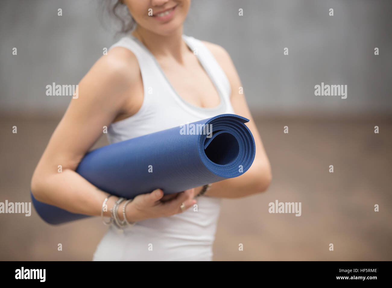 Happy Beautiful Yogi woman holding her mat, close up Stock Photo - Alamy