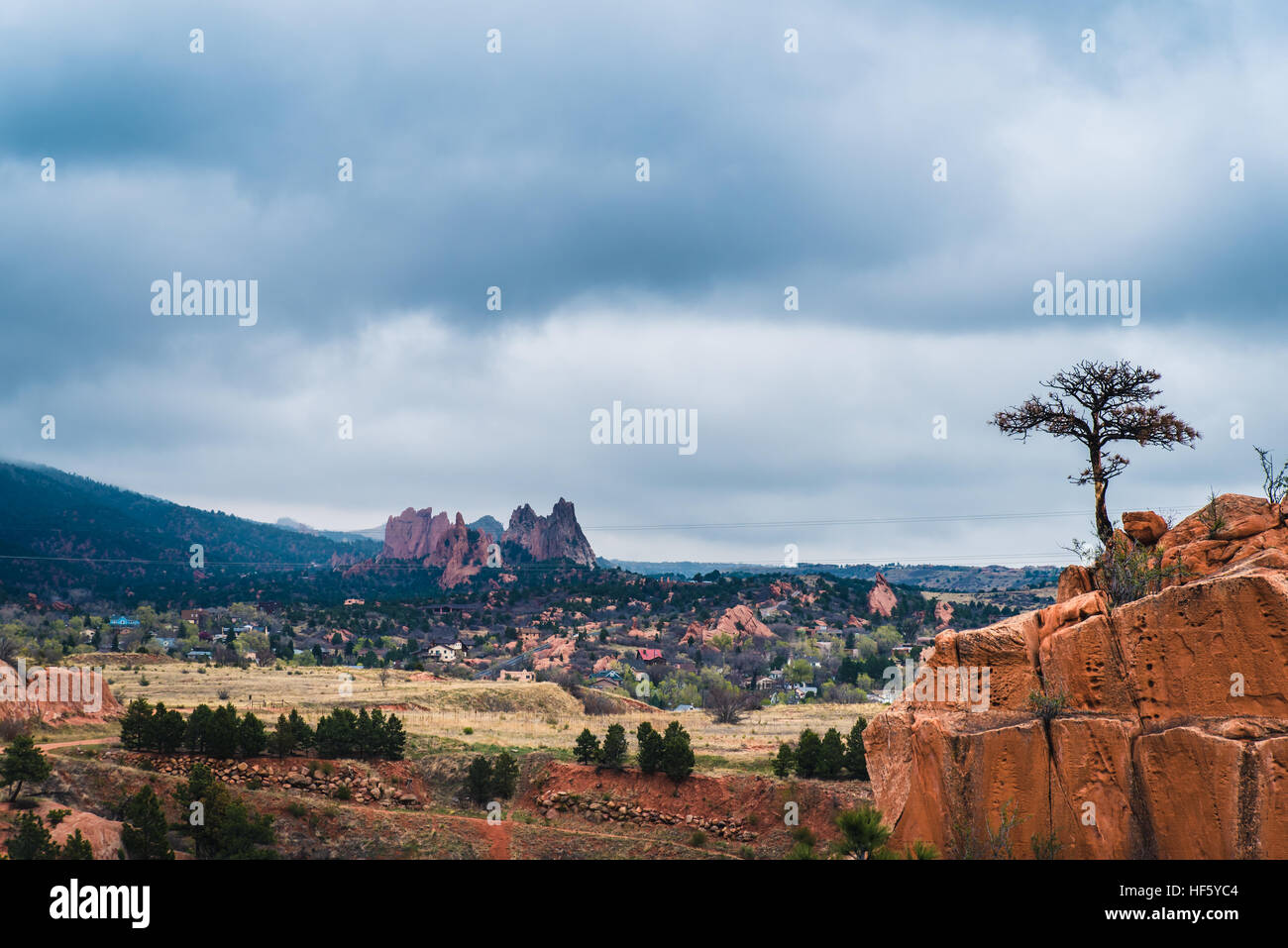 Cloudy landscape with red rock formations Stock Photo - Alamy