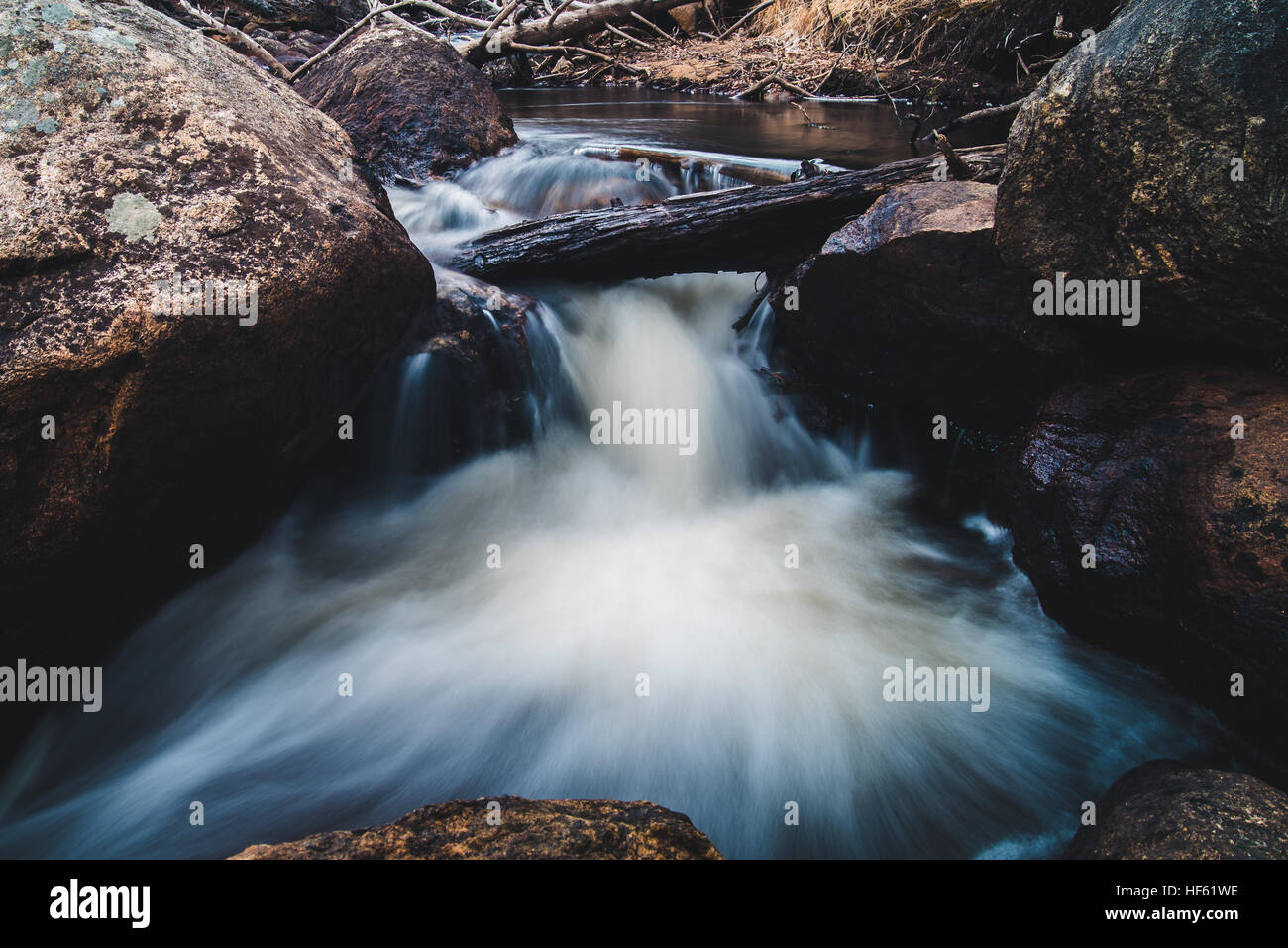 River flowing through large boulders Stock Photo - Alamy