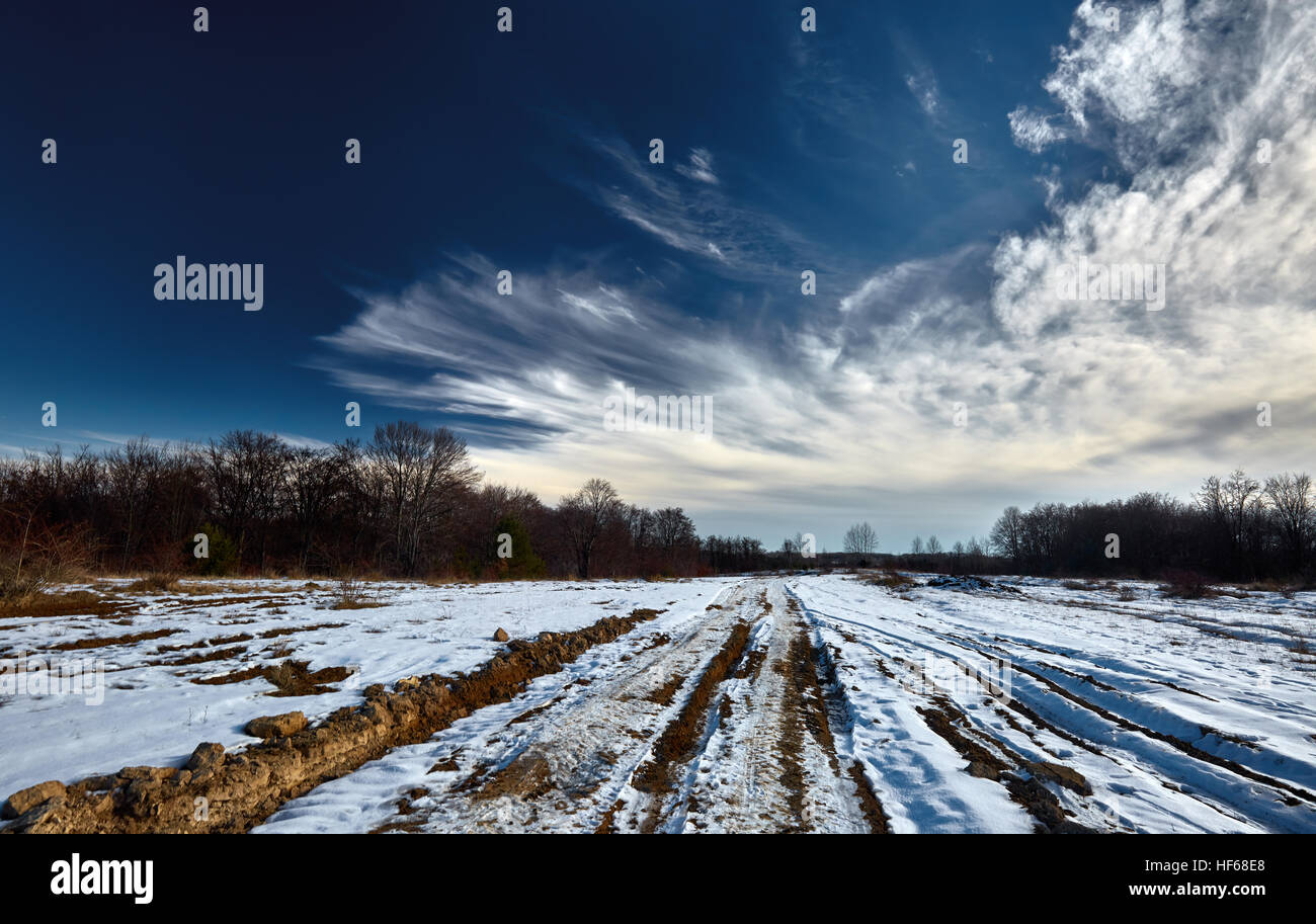 Muddy road covered with snow during winter in the countryside Stock ...