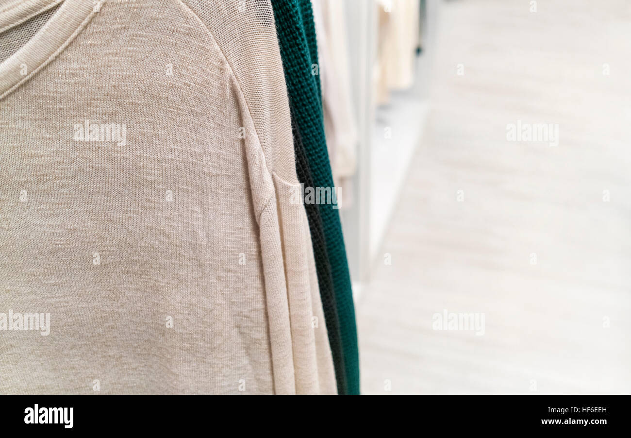 Clothes hanging on a store rack Stock Photo - Alamy