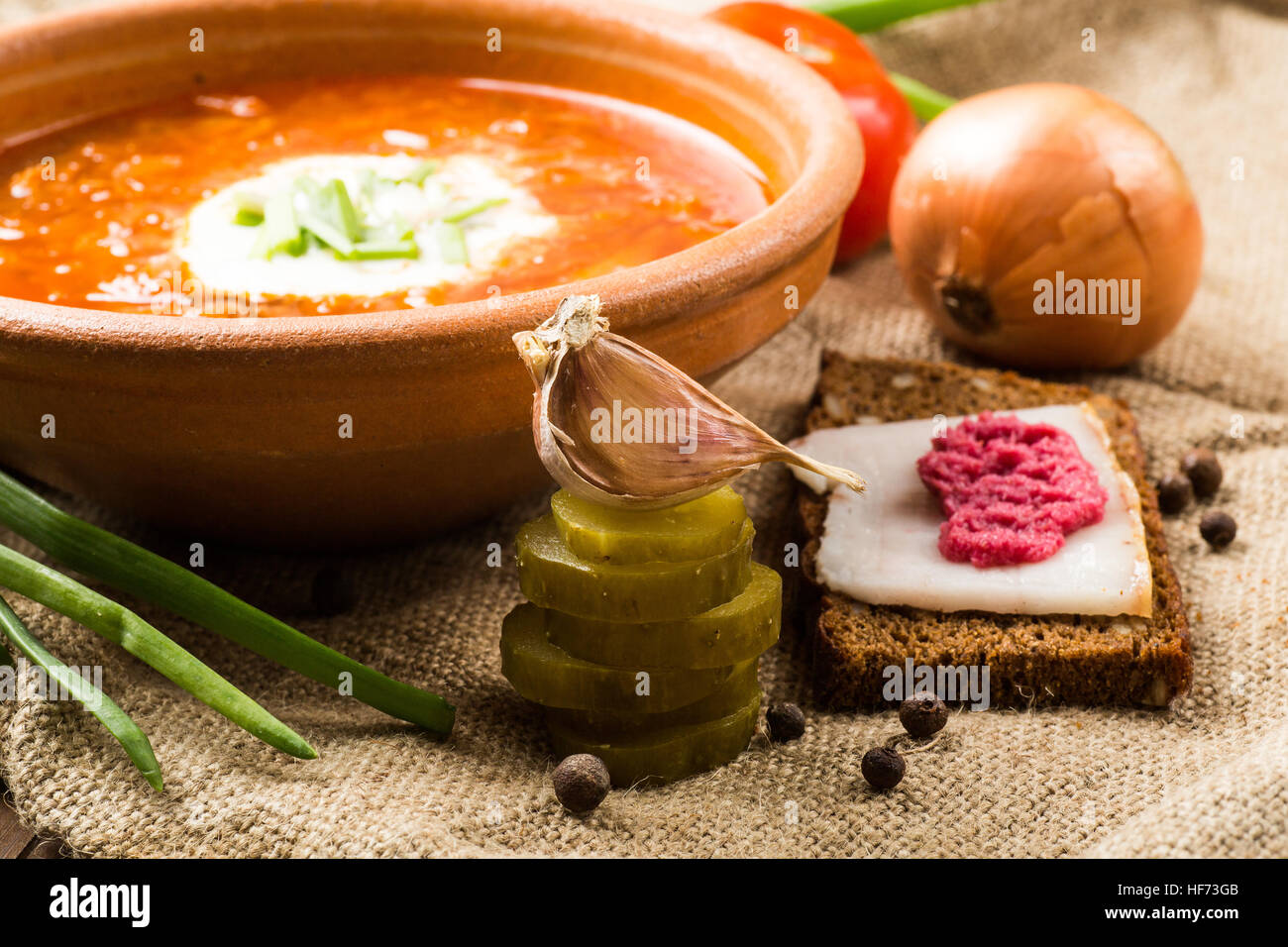 Ukrainian borsch with sour cream and garlic buns on the table Stock ...