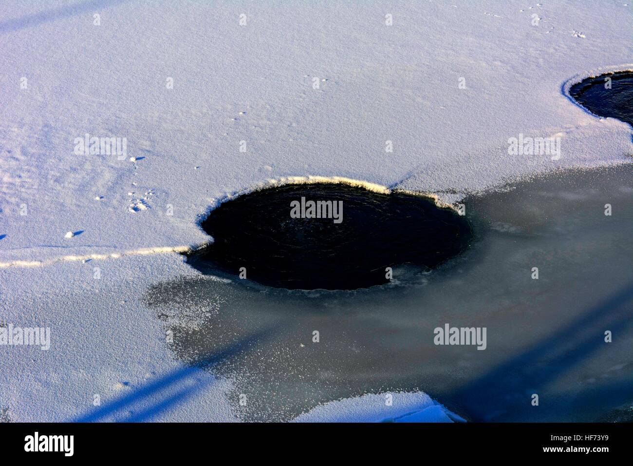 Warm water on the ice of a frozen lake covered with ice in winter Stock ...
