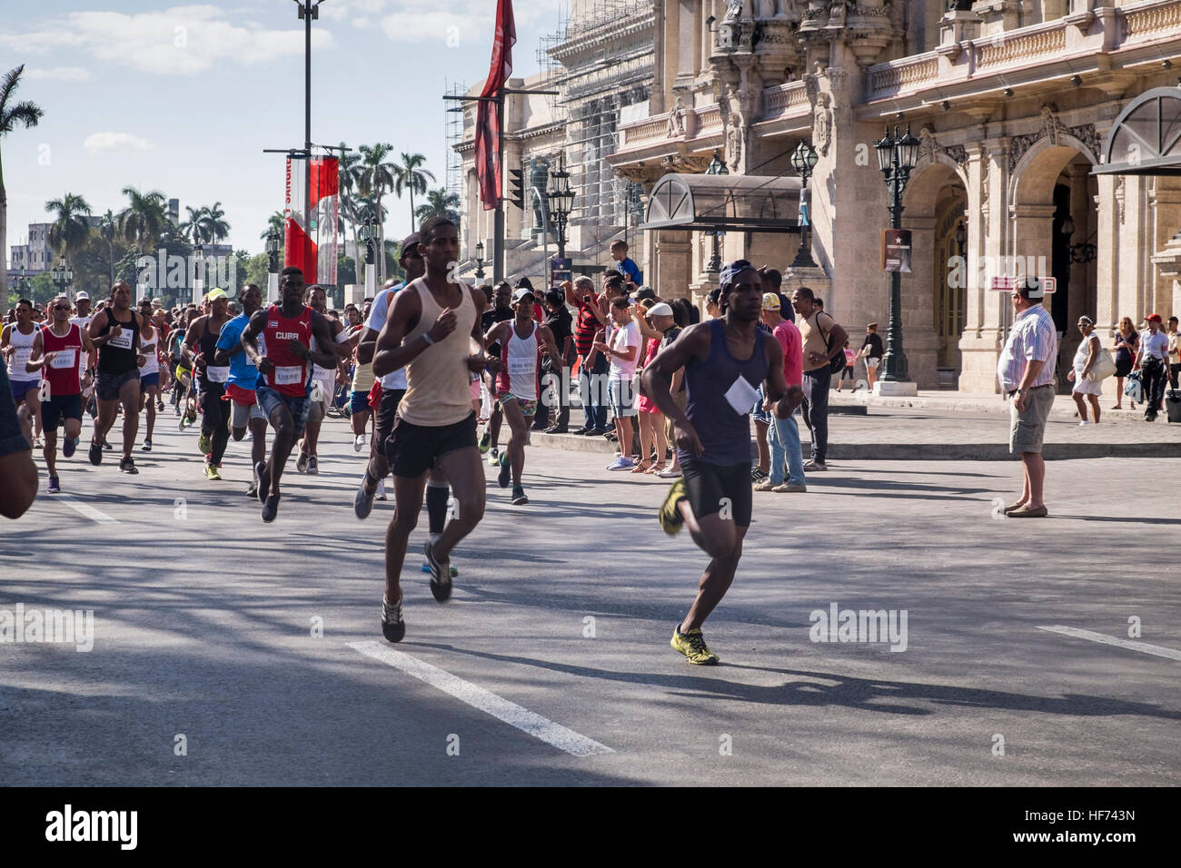Contestants in the Cuban marathon running past the Parque Central, La ...