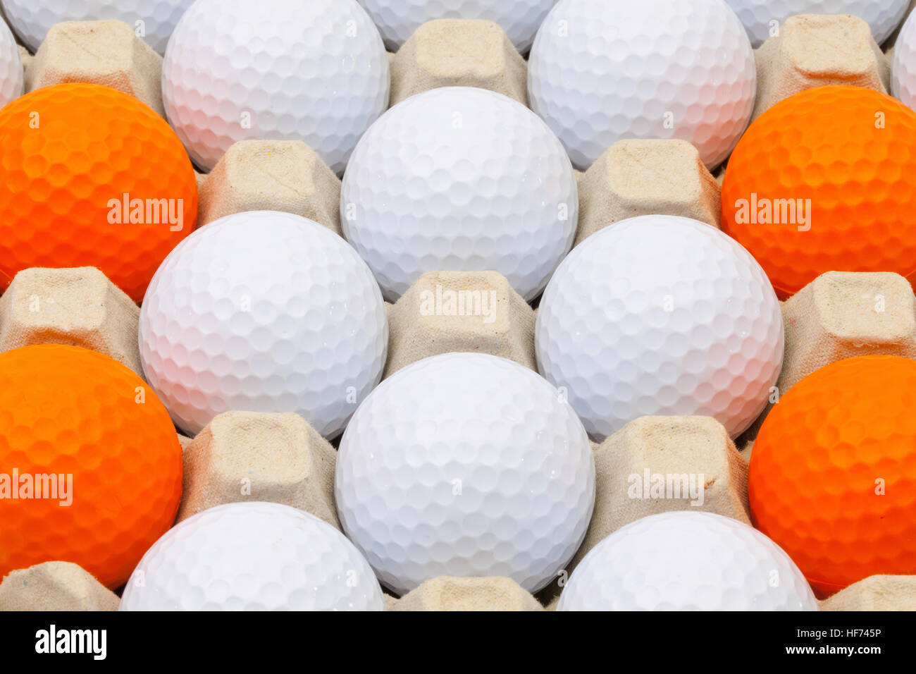 White and orange golf balls in the box for eggs Stock Photo - Alamy