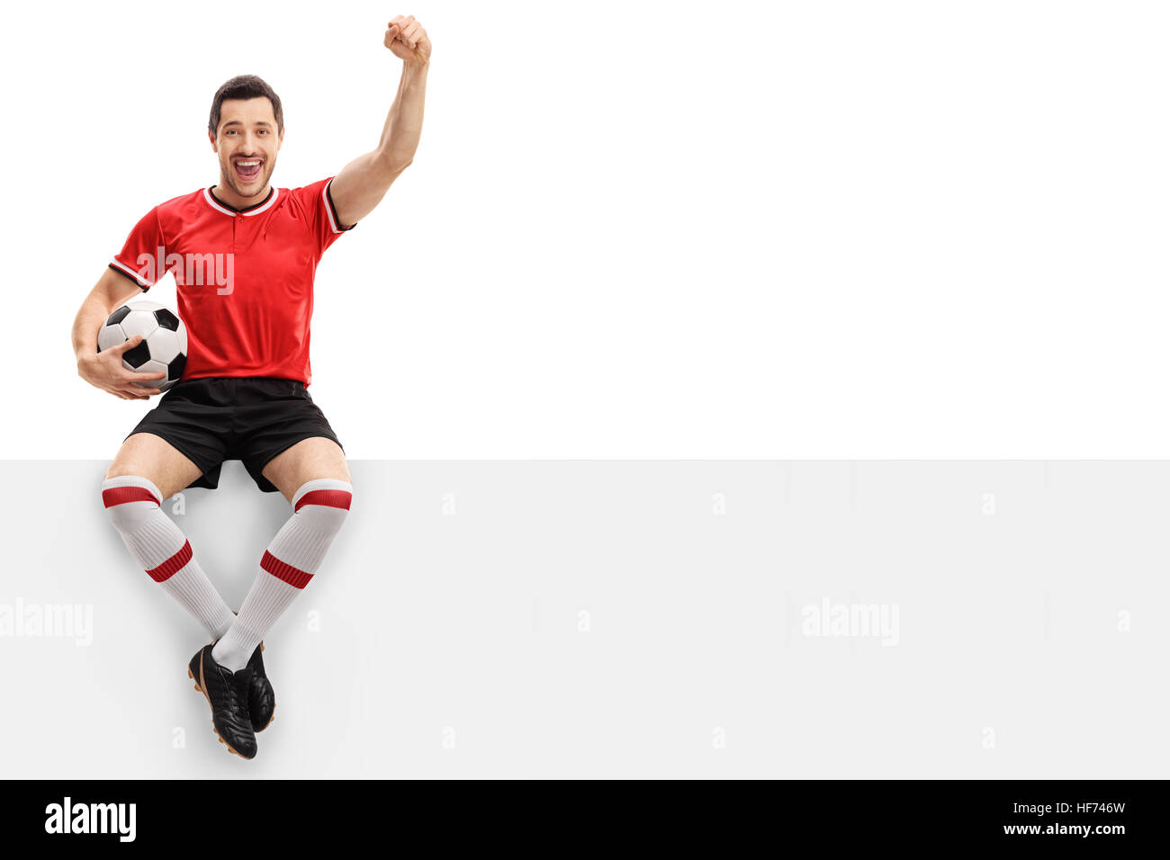 Excited football player sitting on a panel and gesturing happiness ...