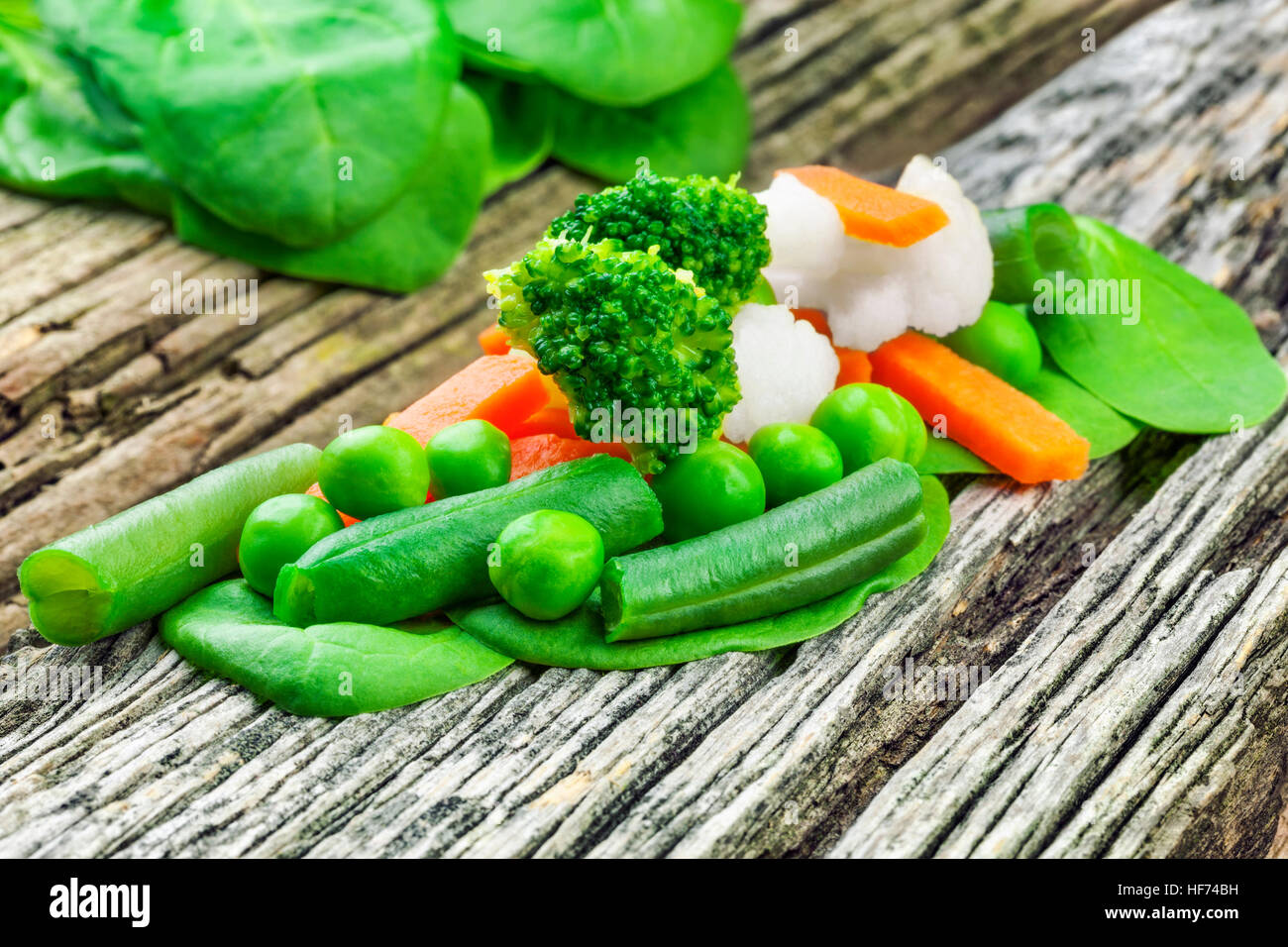 Vegetables on old wooden table on lettuce leaves Stock Photo - Alamy
