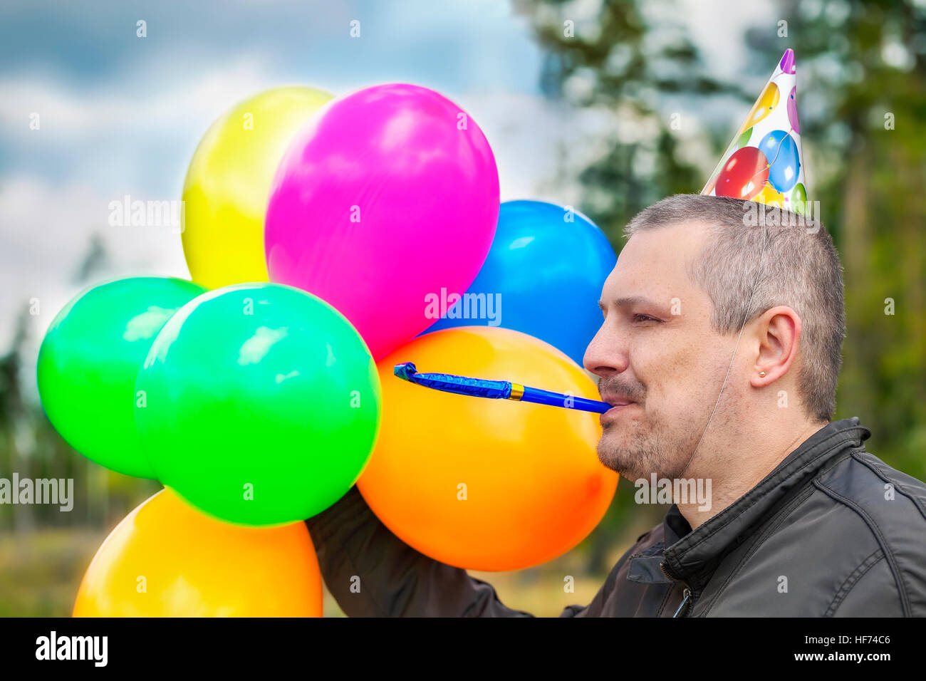 Man with balloons at outdoors Stock Photo - Alamy