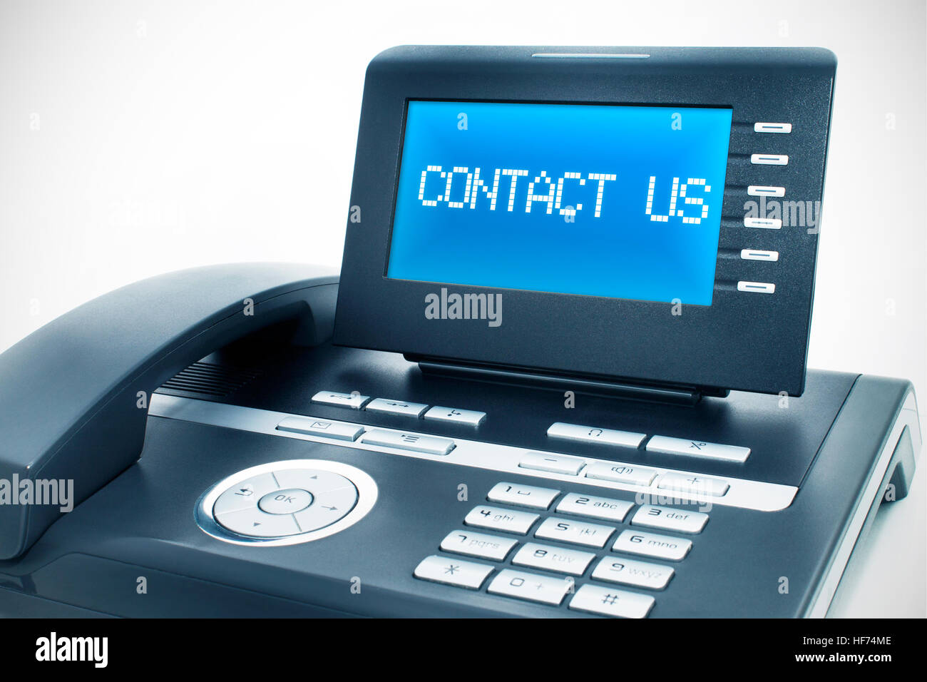 Modern phone with a "contact us" sign on a display Stock Photo - Alamy