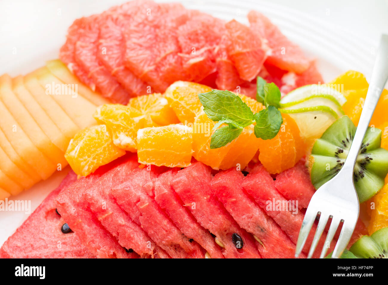 Dish with fresh sliced fruits. Composition on the plate Stock Photo - Alamy