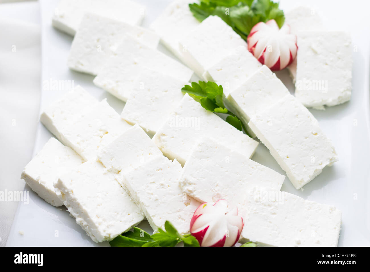 Sliced white cheese. Composition on the plate Stock Photo - Alamy