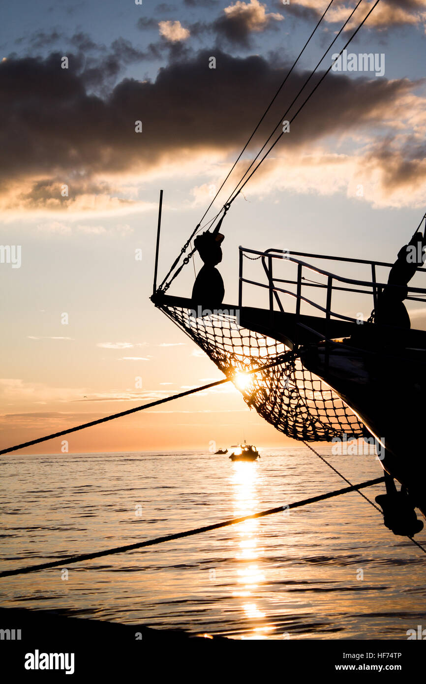 Beautiful sunset at the sea with boats Stock Photo - Alamy