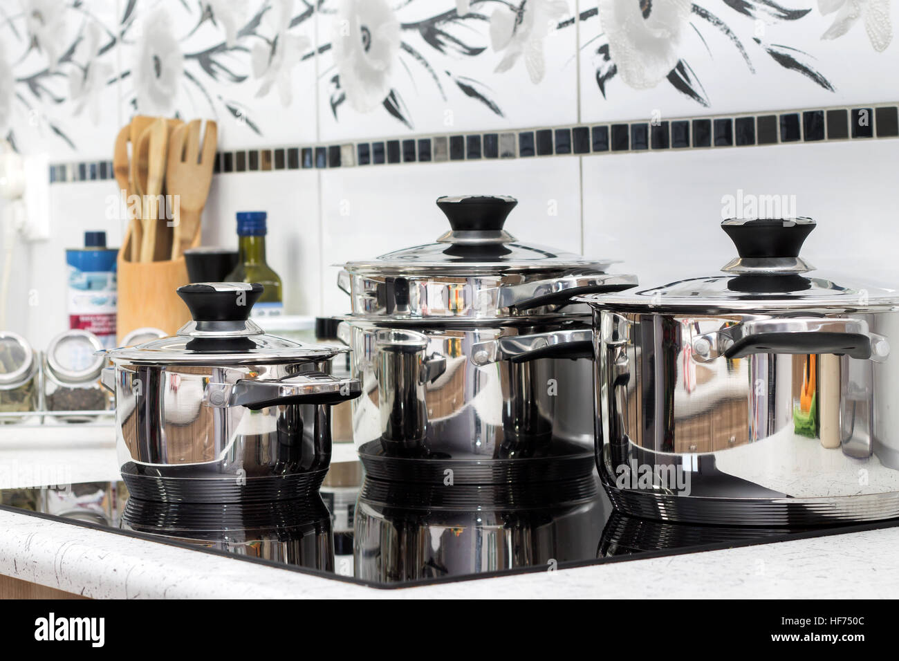 Modern induction cooker with the silver pots Stock Photo - Alamy