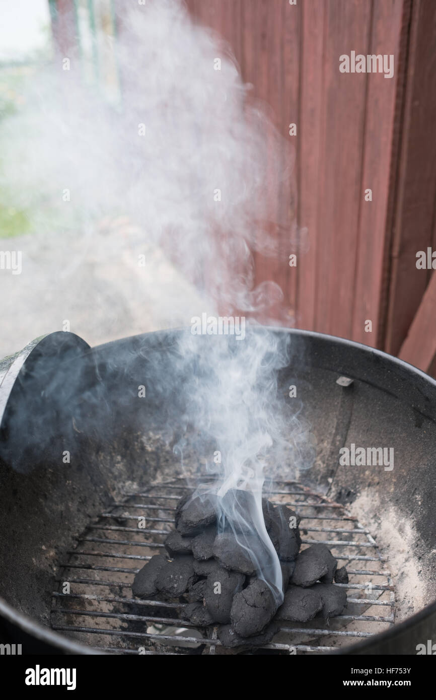 Smoke coming out of grill aganist brown wall Stock Photo - Alamy