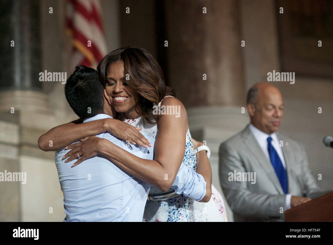 U.S. First Lady Michelle Obama hugs a newly naturalized American ...