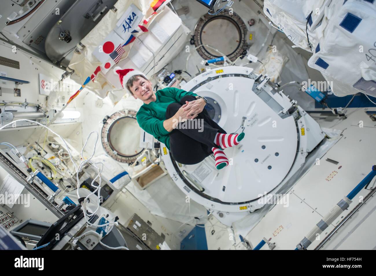 NASA Expedition 50 prime crew astronaut Peggy Whitson wears a Santa ...