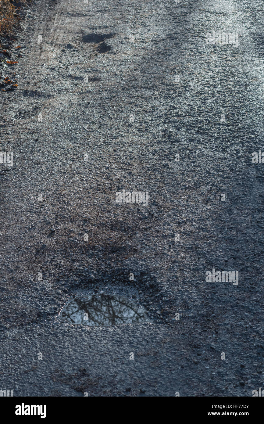Road frost damage: ravelling cracked tarmac surface & pothole of rural ...