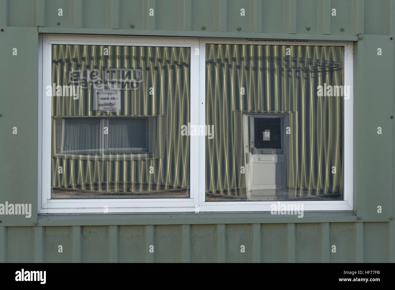 Reflections of an industrial Unit in a workshop window Stock Photo - Alamy