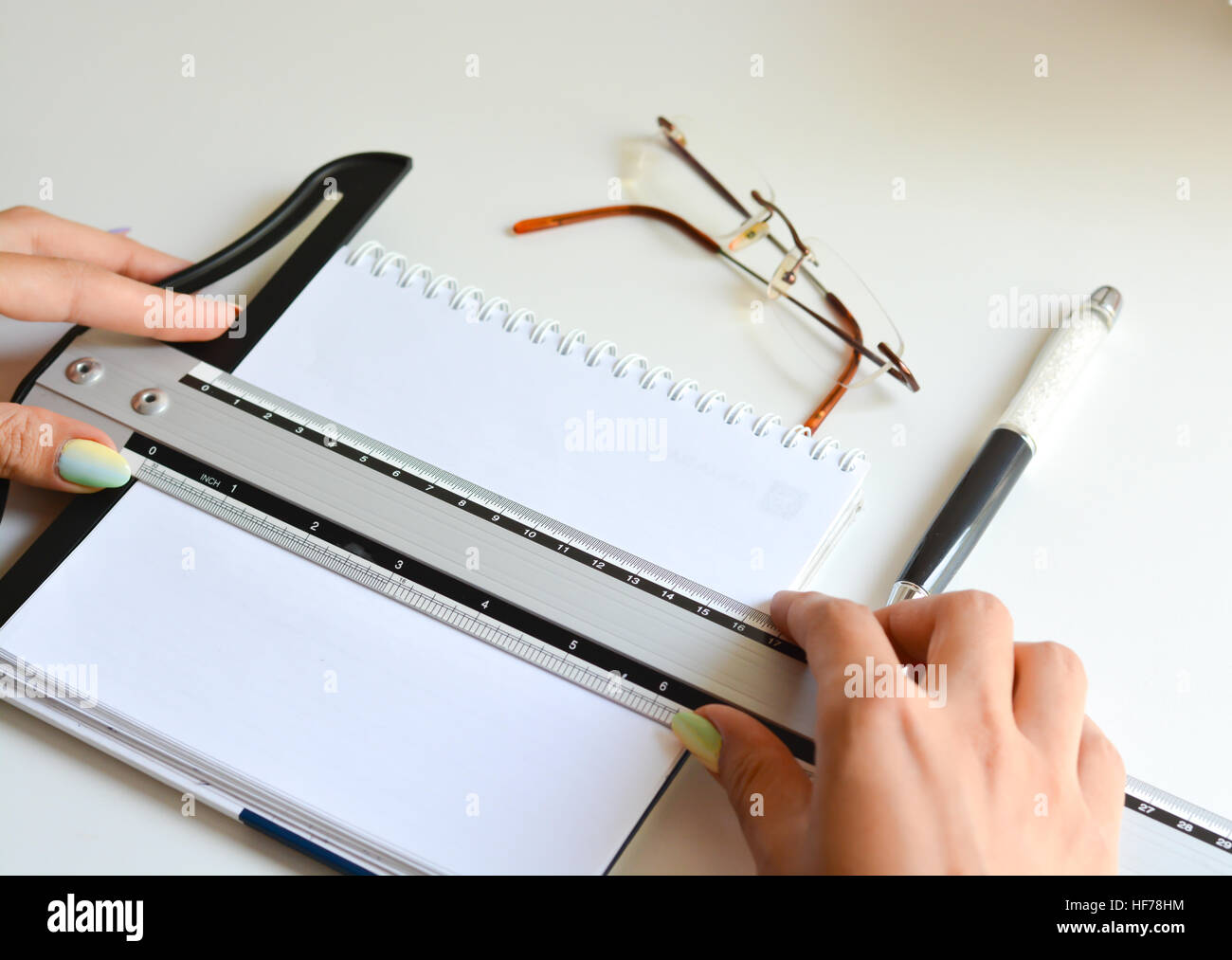 Woman measuring an empty notebook. Template for text Stock Photo - Alamy