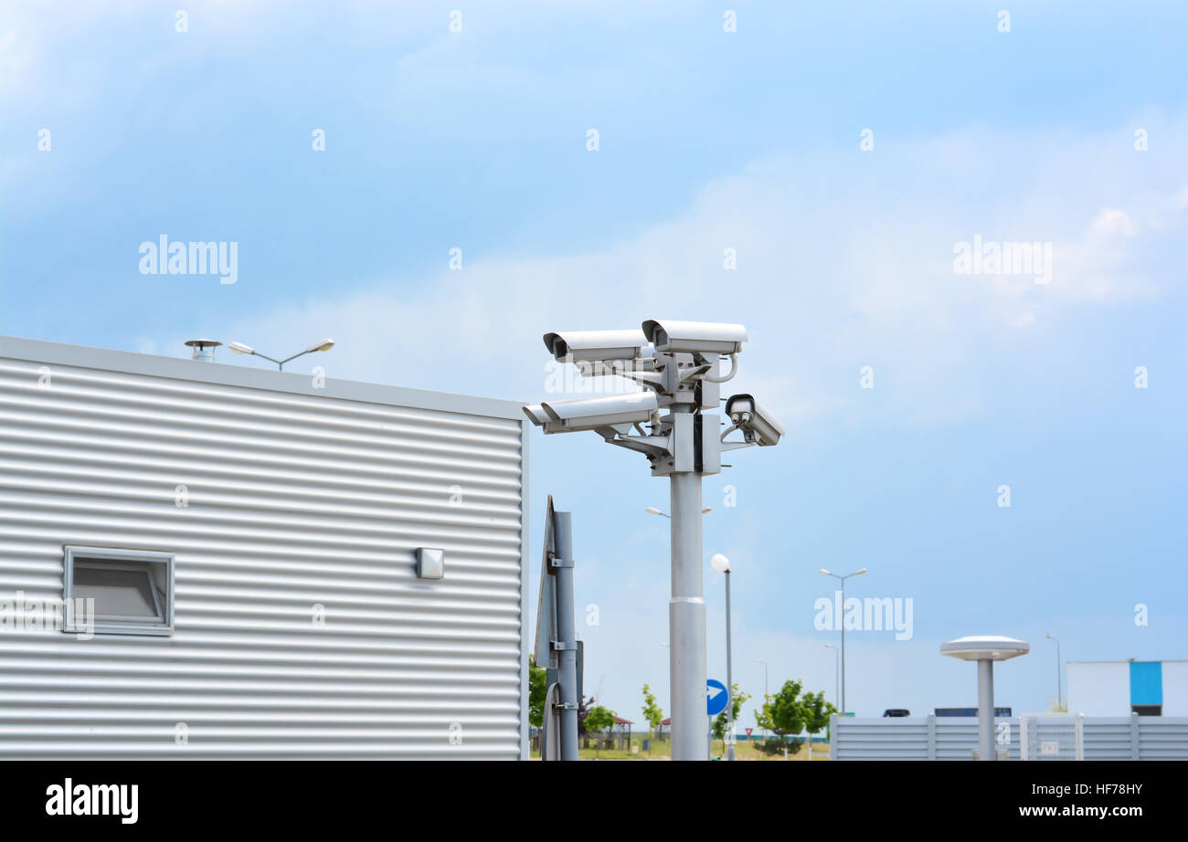Multiple surveillance cameras on blue sky Stock Photo - Alamy