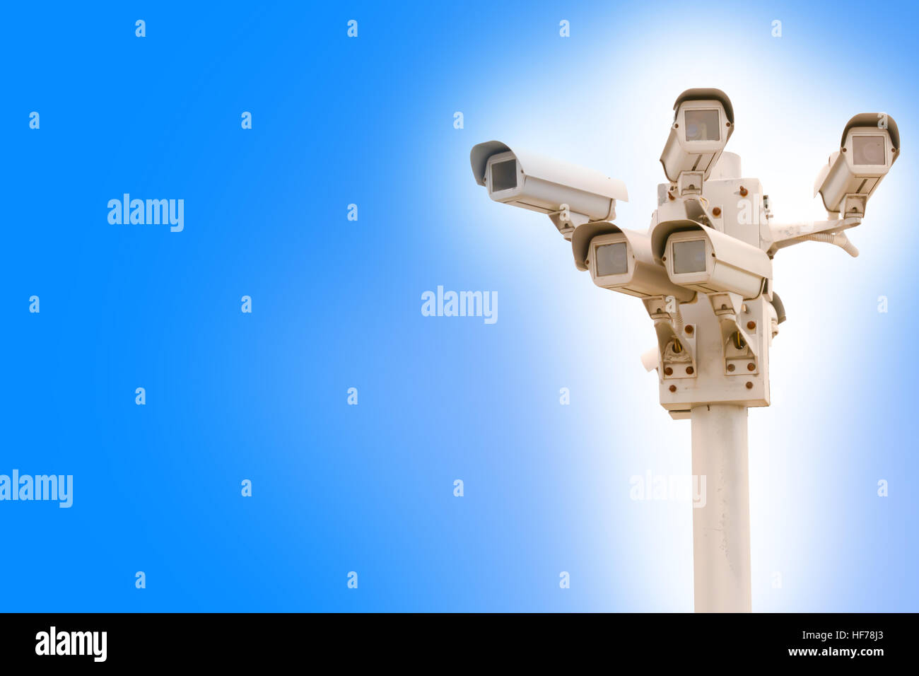 Multiple surveillance cameras on blue sky Stock Photo - Alamy