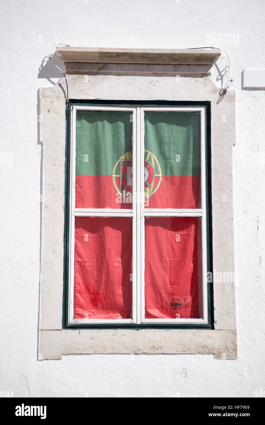 the portugese flag at a window in the old town of Faro at the east ...