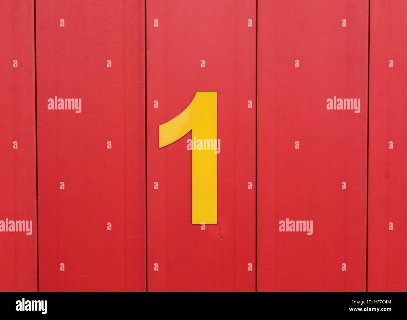 the number one, yellow, set against bright red wood Stock Photo - Alamy