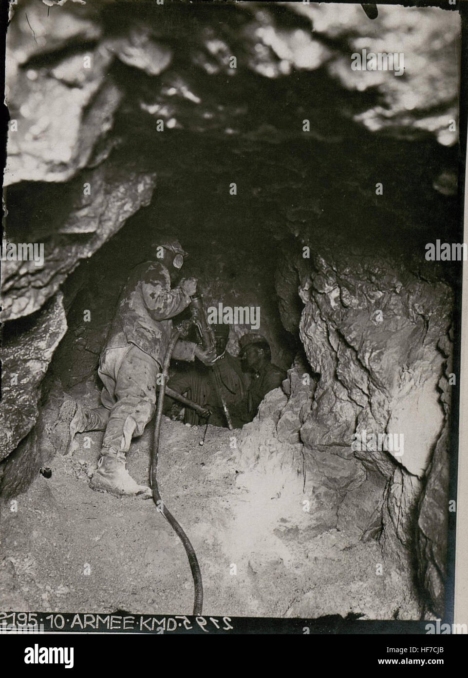 A wartime photograph showing a drilling machine inside a cave at Vršič ...