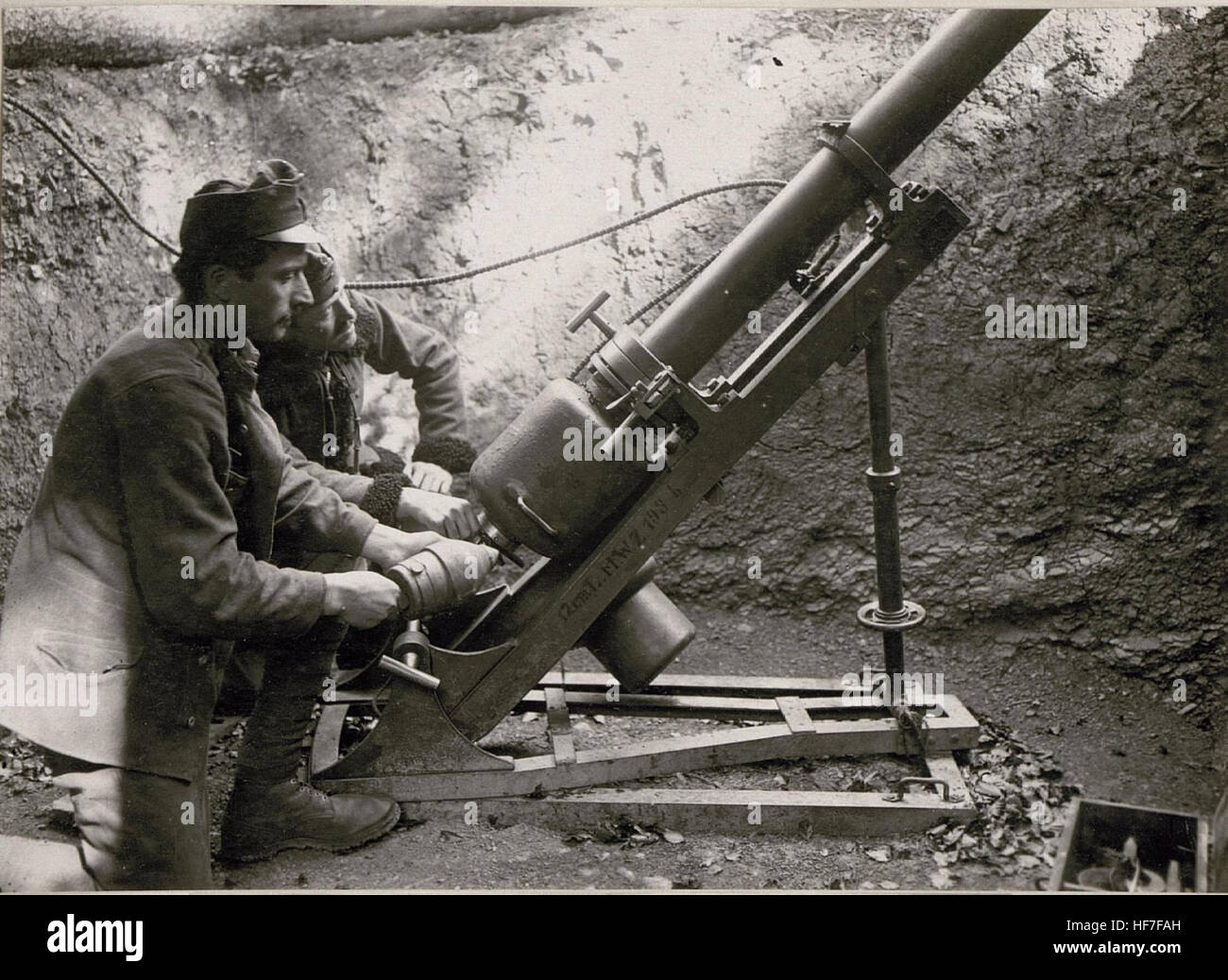 The image features a 12 cm Minenwerfer (mine launcher) in position ...