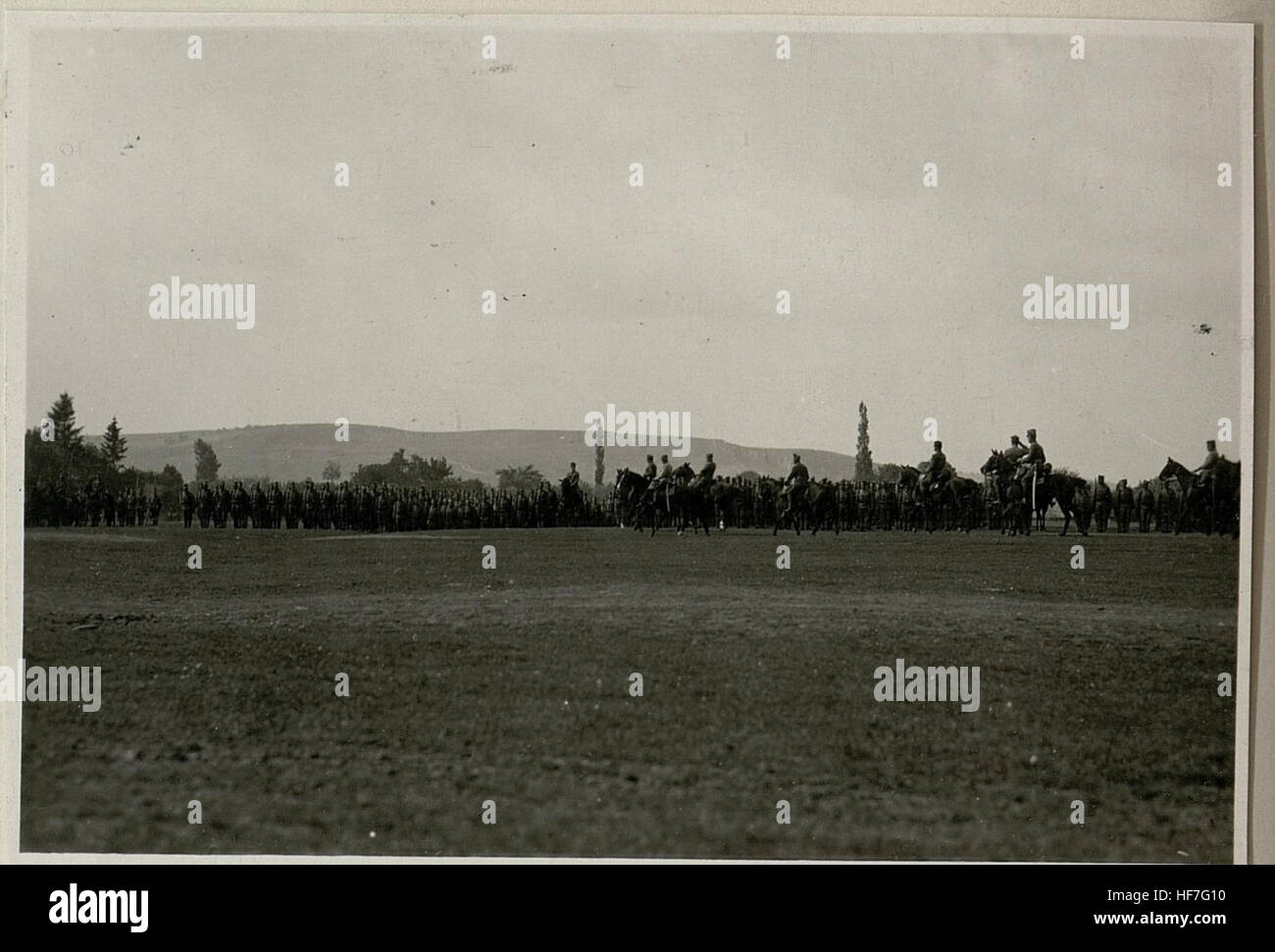 This historical image depicts the defilement of military regiments ...