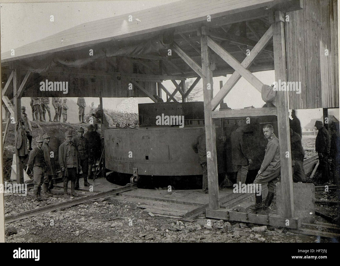 This historical photograph shows the mounting of a 42 cm howitzer in ...