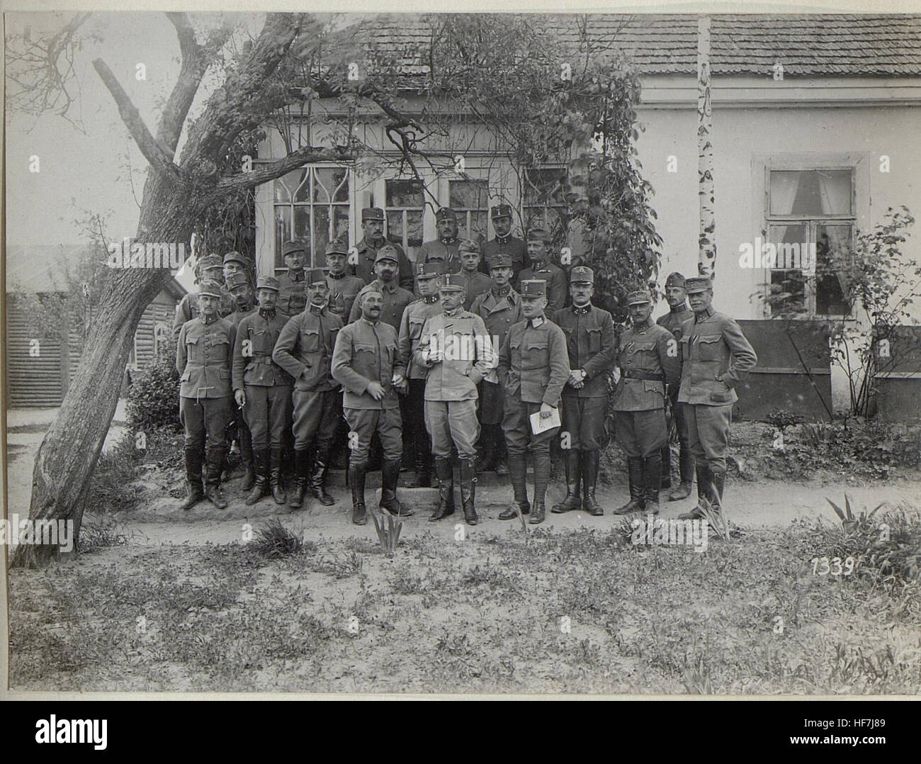 This historical photograph shows officers and soldiers posing in front ...