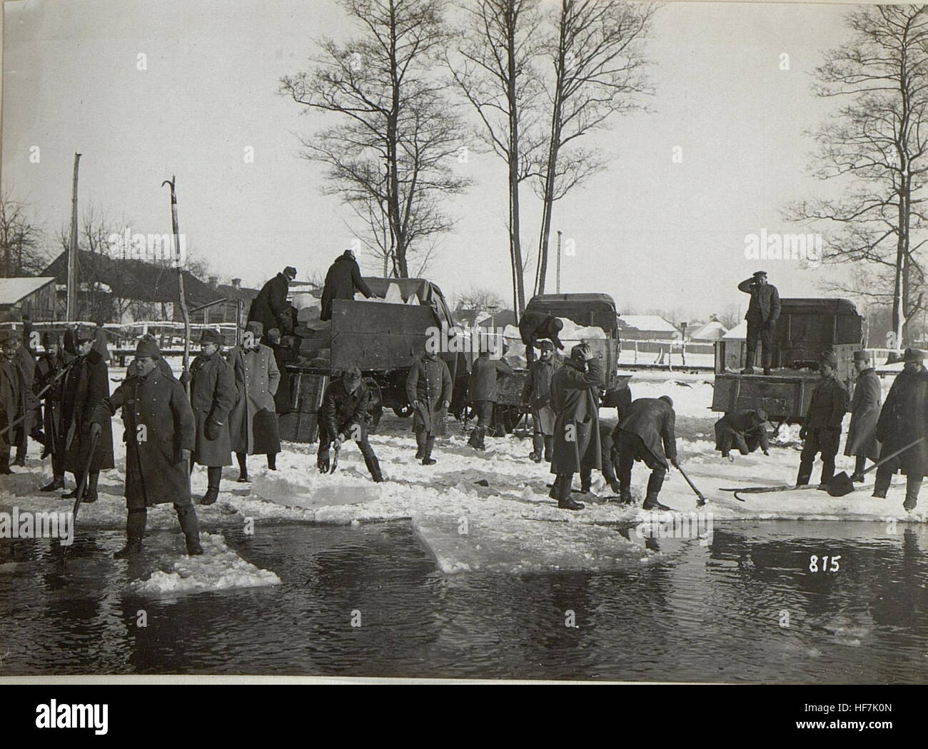 This photograph captures the process of ice harvesting in wintery ...