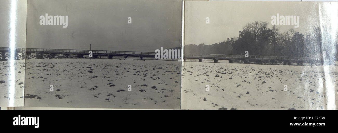 This historical photograph, taken during World War I, depicts a bridge ...