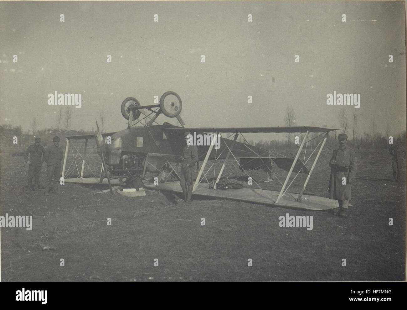This image depicts a crashed aircraft from World War I, illustrating ...