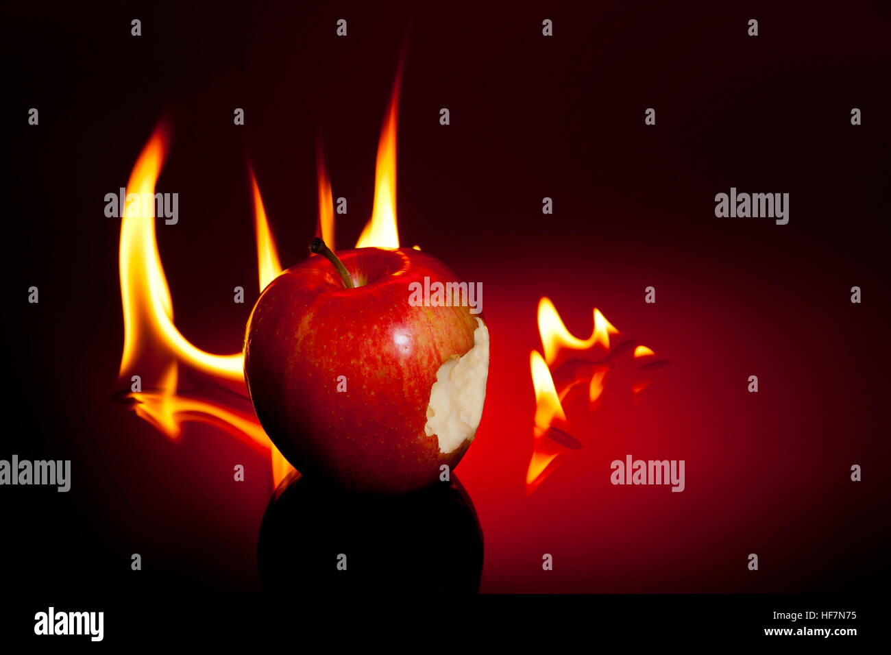 One sinful bite from apple with flames Stock Photo - Alamy